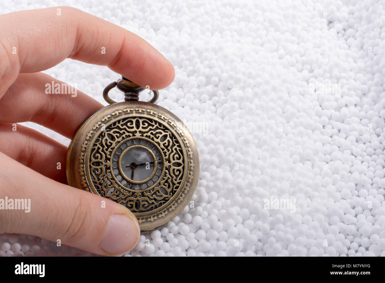 Retro style pocket watch in hand on white background Stock Photo - Alamy