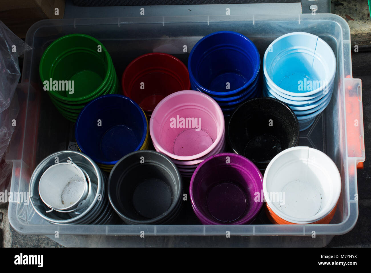 Little set of buckets of various colors in a market place Stock Photo ...