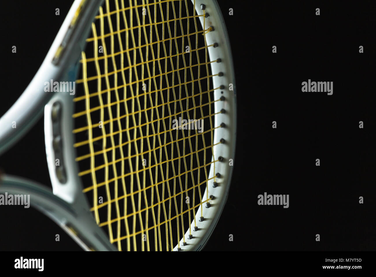Tennis racket on black background Stock Photo - Alamy