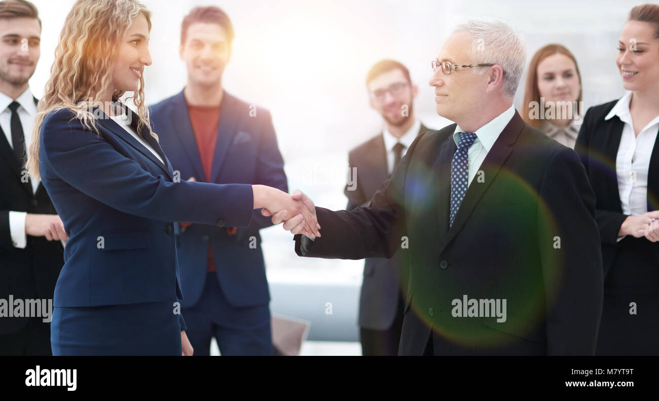 handshake serious businessman and business woman in the presence of a business team Stock Photo ...