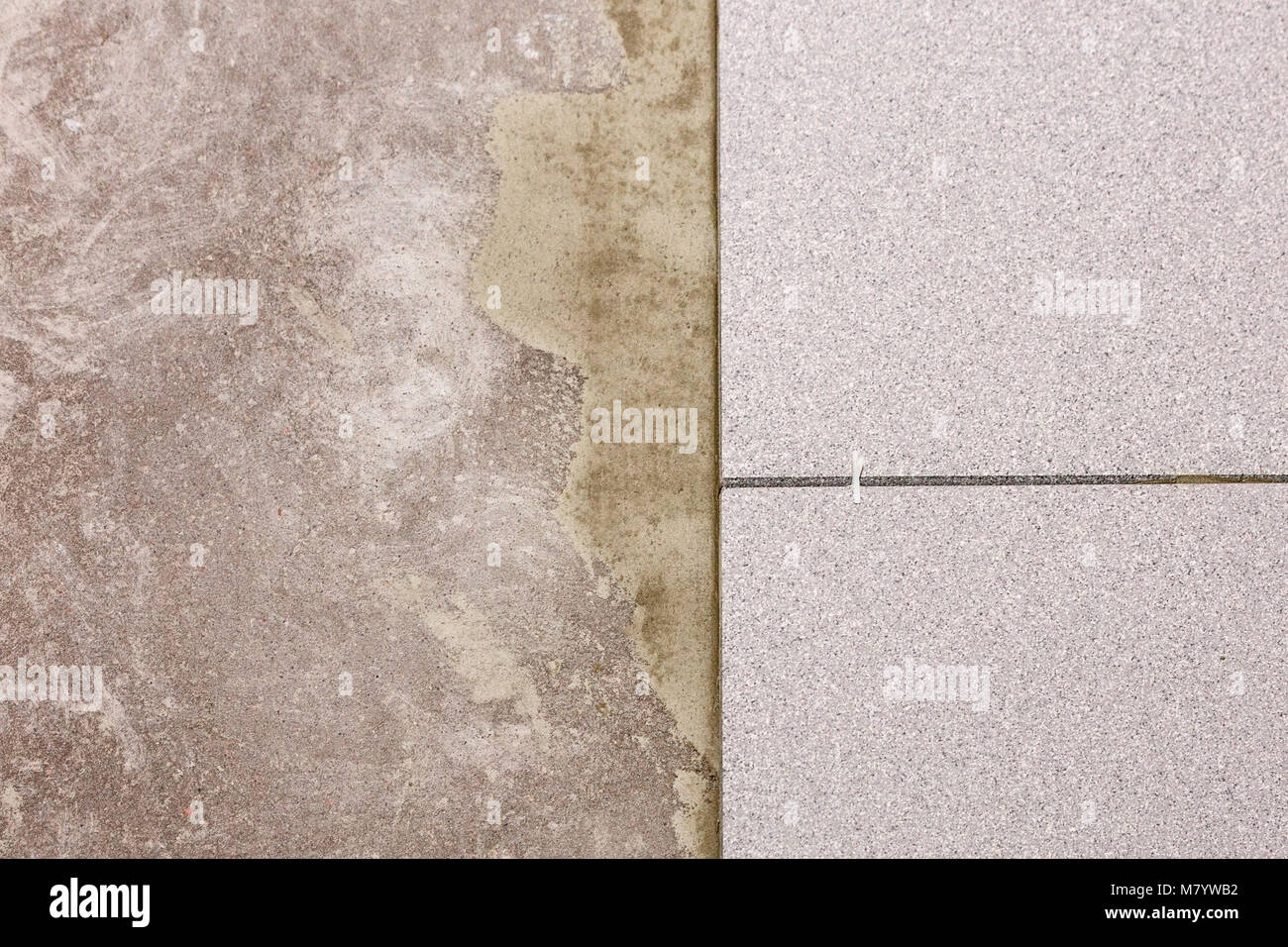 Fragment of the floor, in the process of laying ceramic tiles, close-up ...