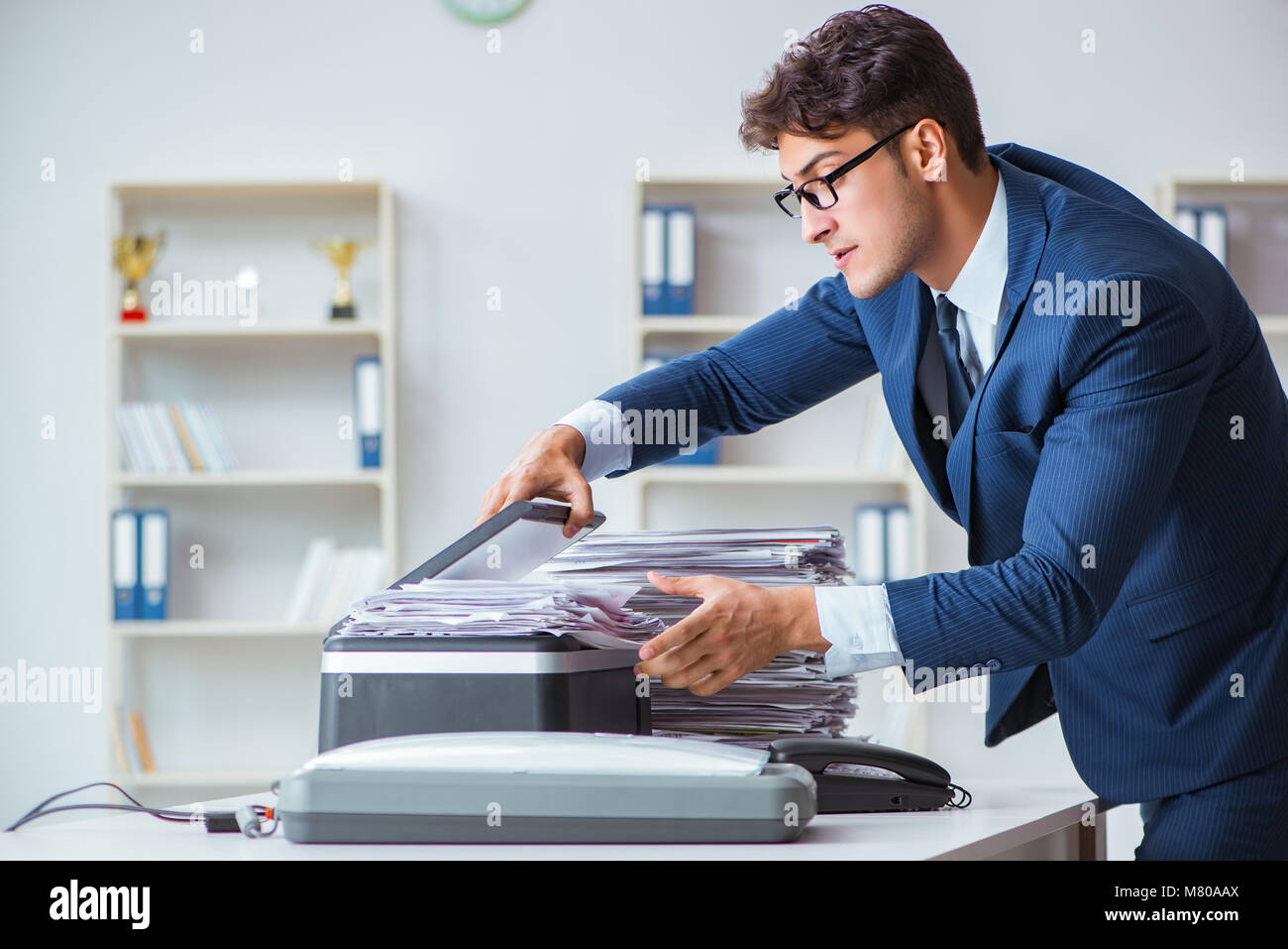Businessman making copies in copying machine Stock Photo - Alamy