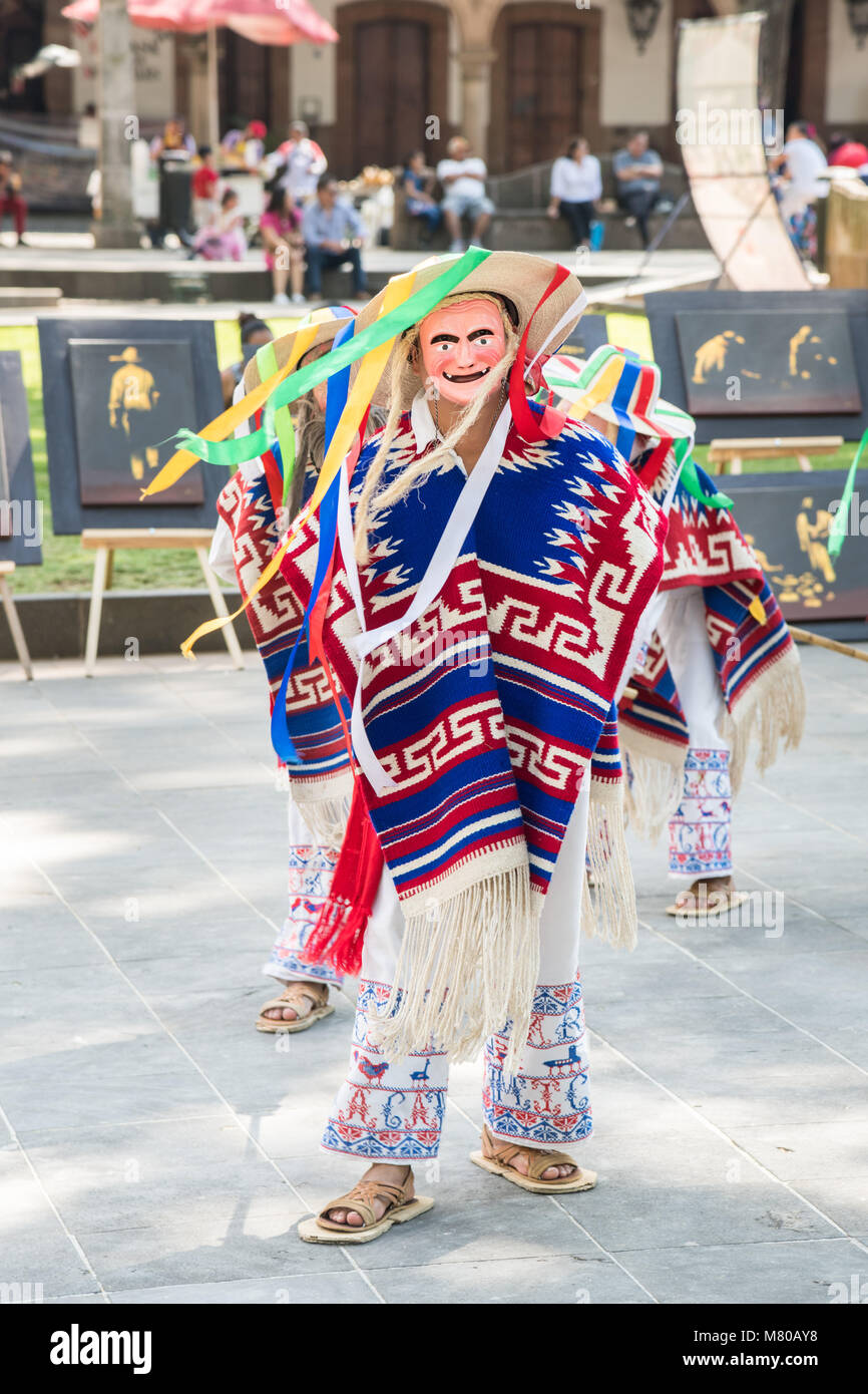 Costumed as old men traditional dancers perform the La Danza de los ...