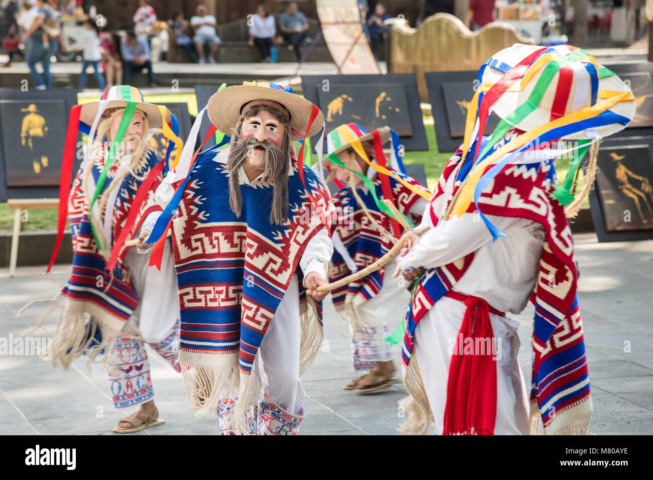 Costumed as old men traditional dancers perform the La Danza de los ...