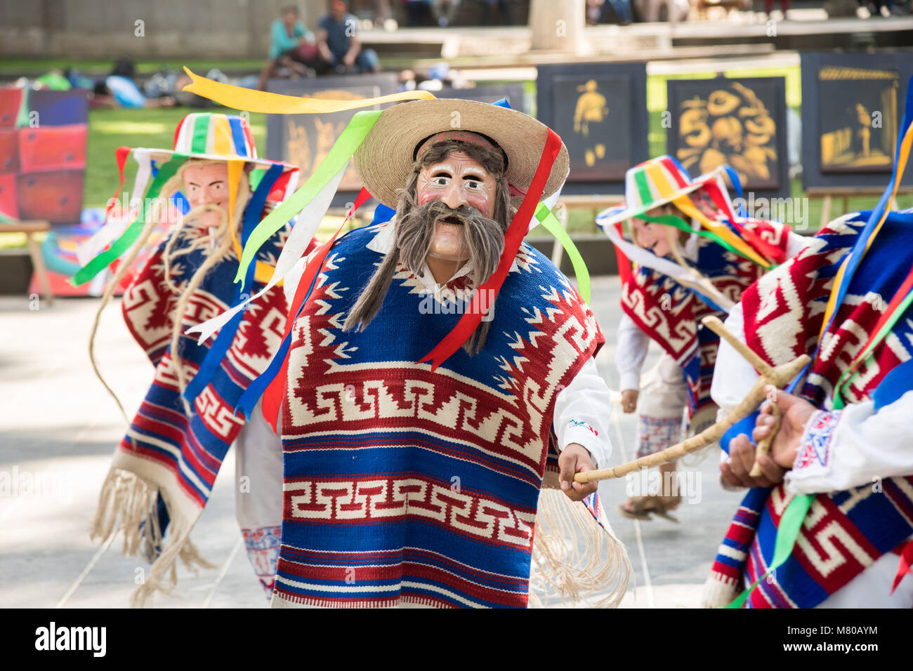 Costumed as old men traditional dancers perform the La Danza de los ...