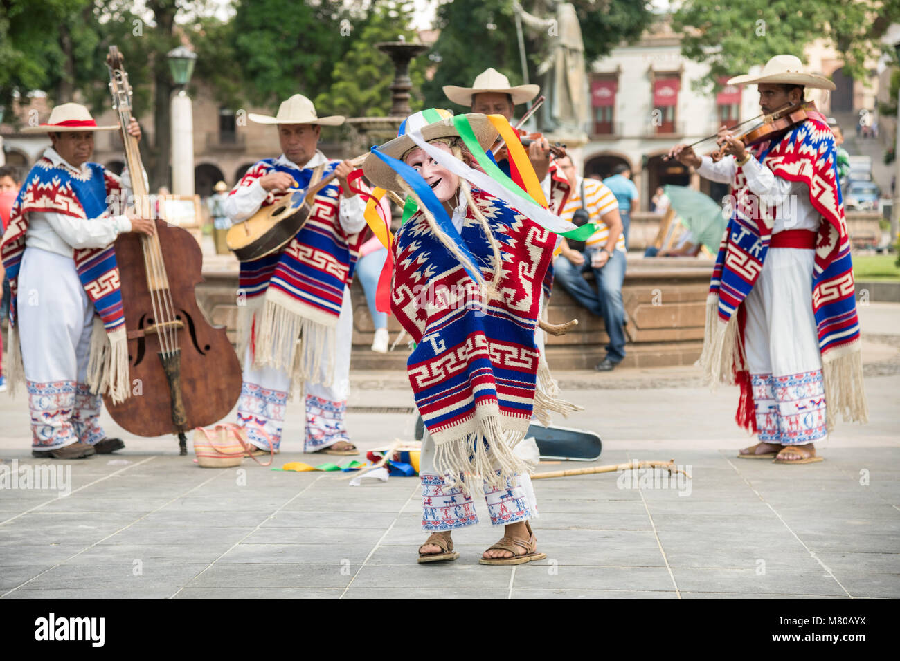 Costumed as old men traditional dancers perform the La Danza de los ...