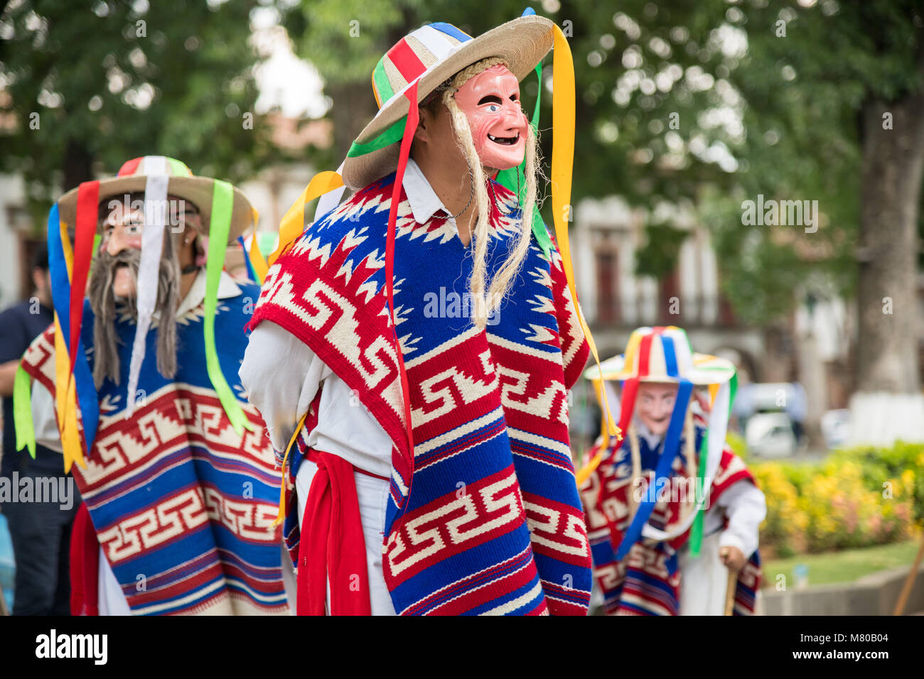 Costumed as old men traditional dancers perform the La Danza de los ...