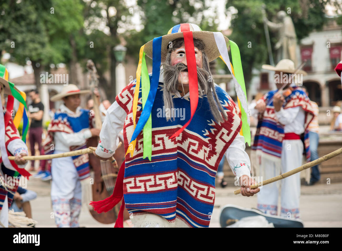 Costumed as old men traditional dancers perform the La Danza de los ...