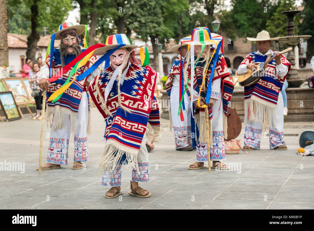 Costumed as old men traditional dancers perform the La Danza de los ...