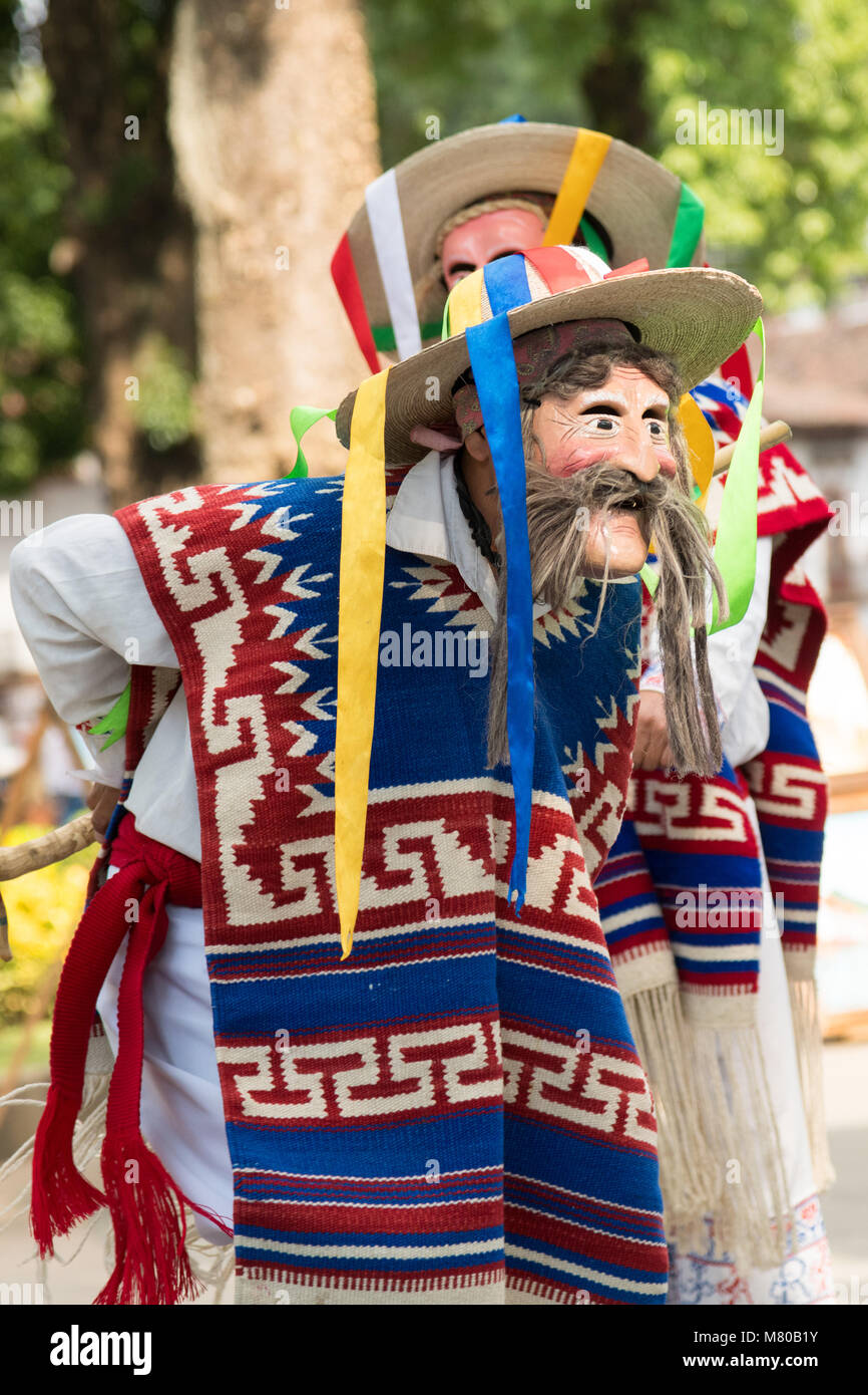 Costumed as old men traditional dancers perform the La Danza de los ...