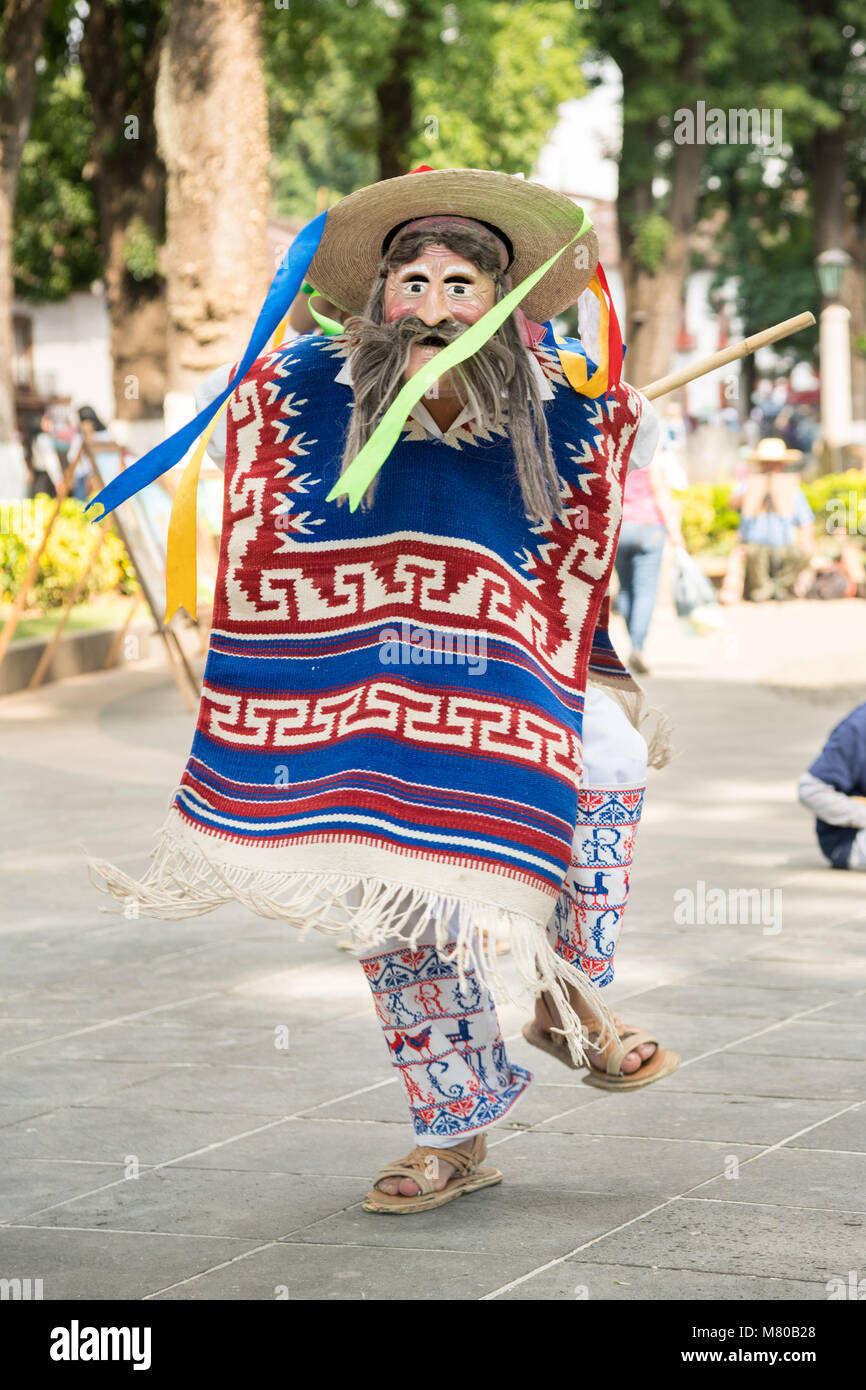 Costumed as old men traditional dancers perform the La Danza de los ...