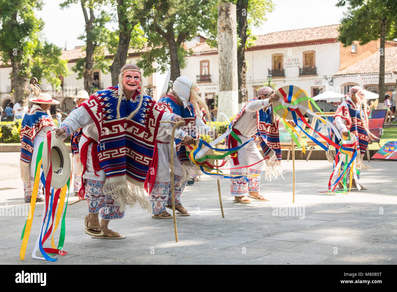 Costumed as old men traditional dancers perform the La Danza de los ...