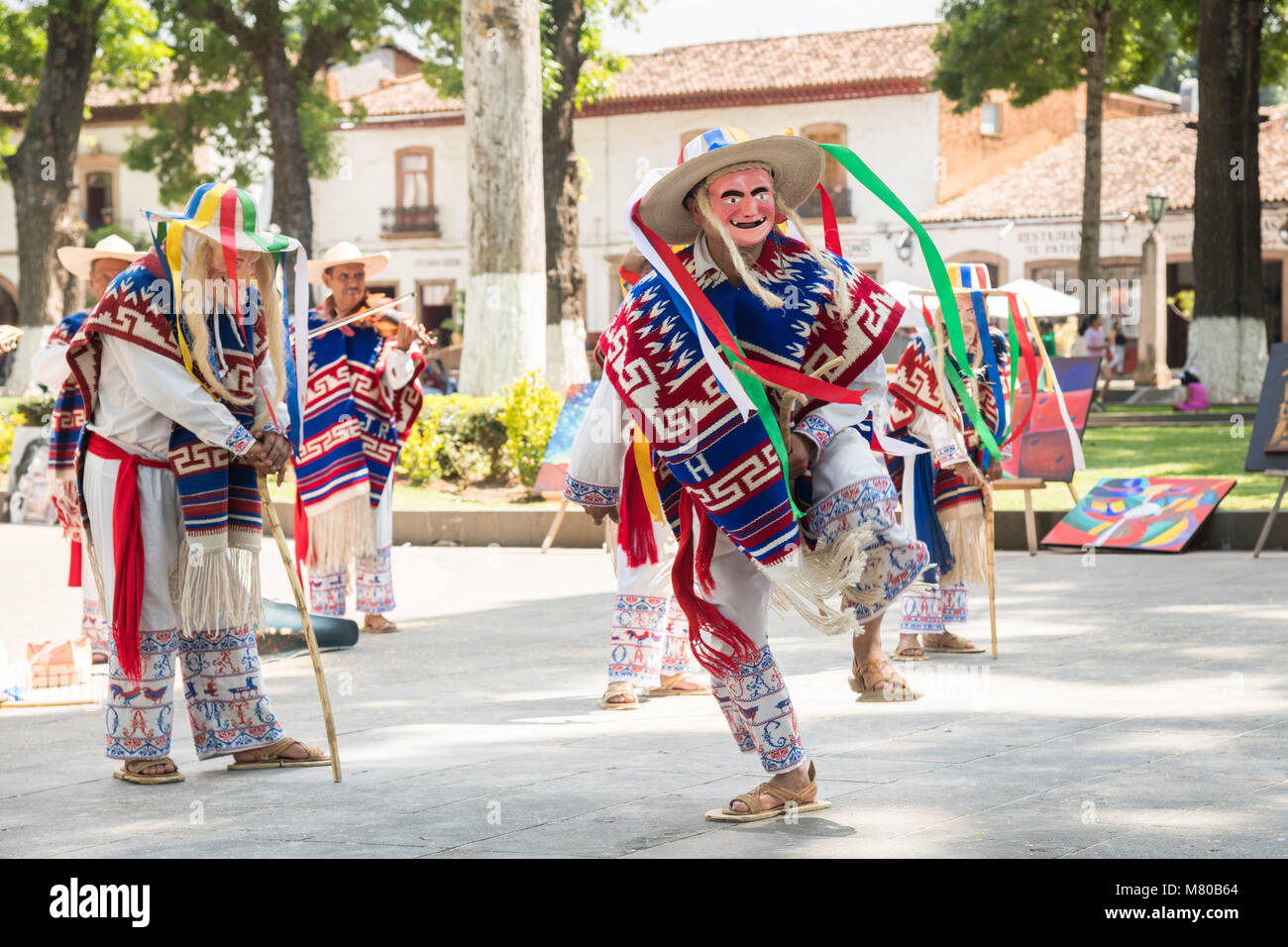 Costumed as old men traditional dancers perform the La Danza de los ...