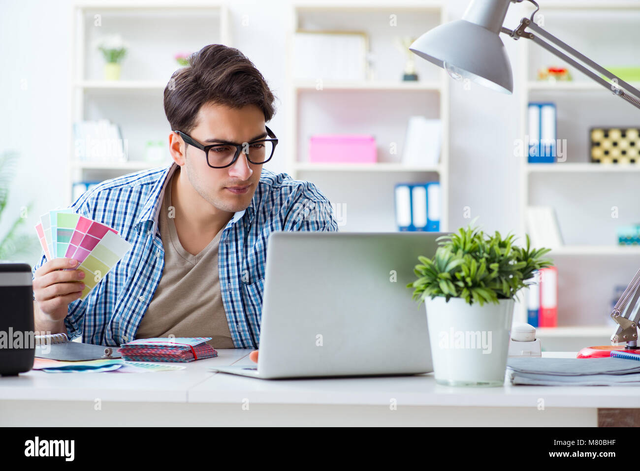 Young designer choosing colours for new project Stock Photo - Alamy