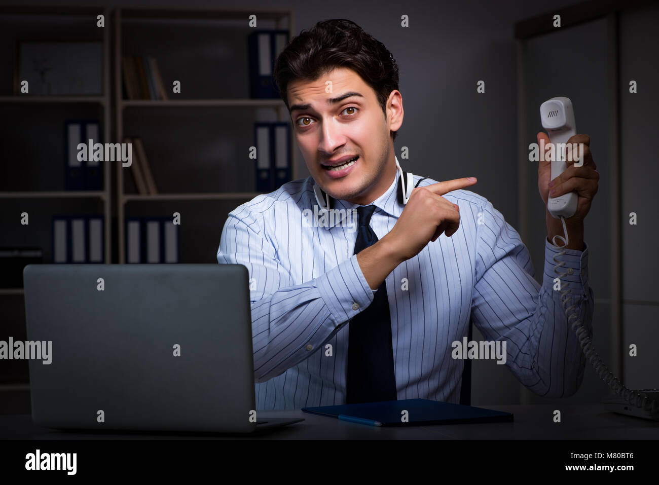 Tired and exhausted helpdesk operator during night shift Stock Photo ...