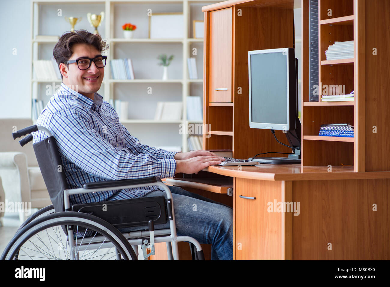 Disabled student studying at home on wheelchair Stock Photo - Alamy