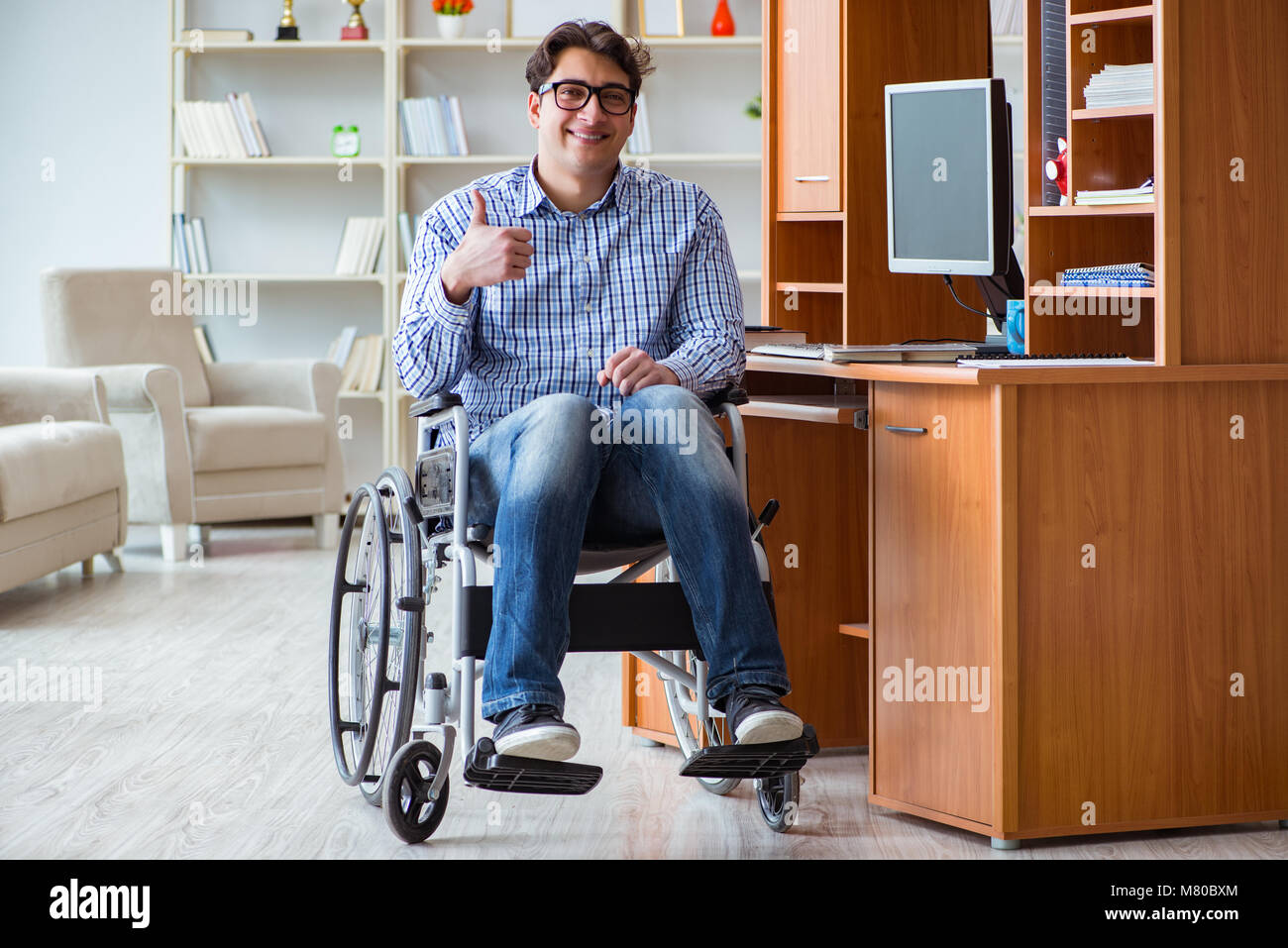 Disabled student studying at home on wheelchair Stock Photo - Alamy