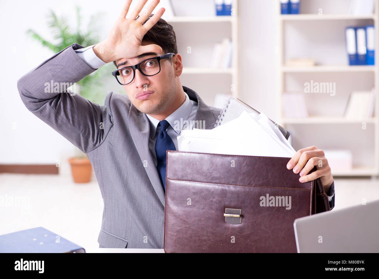 Employee with too much work taking it home Stock Photo - Alamy