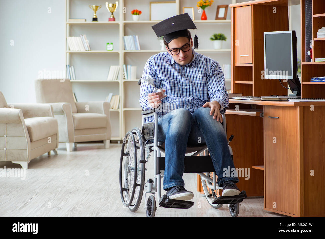 Disabled student studying at home on wheelchair Stock Photo - Alamy