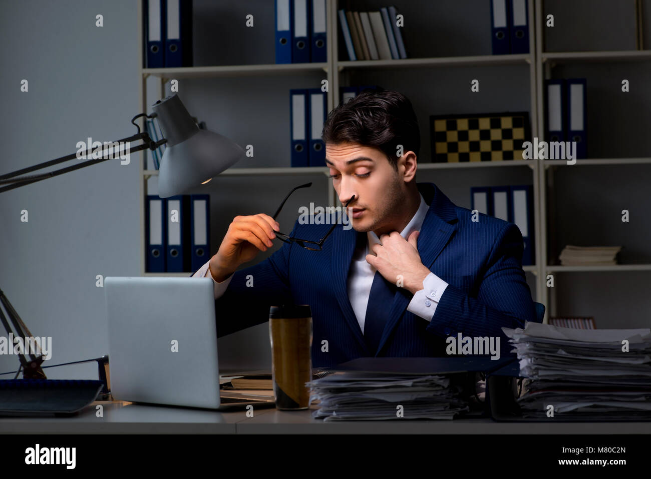 Employee working late to finish important deliverable task Stock Photo ...