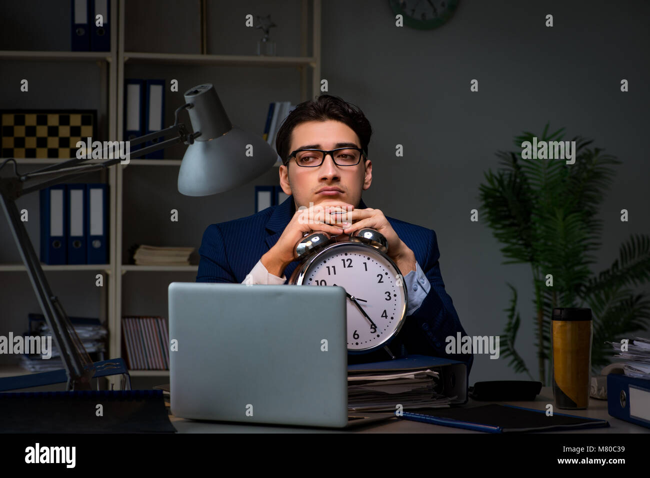 Employee staying late to finish work on auditing Stock Photo - Alamy