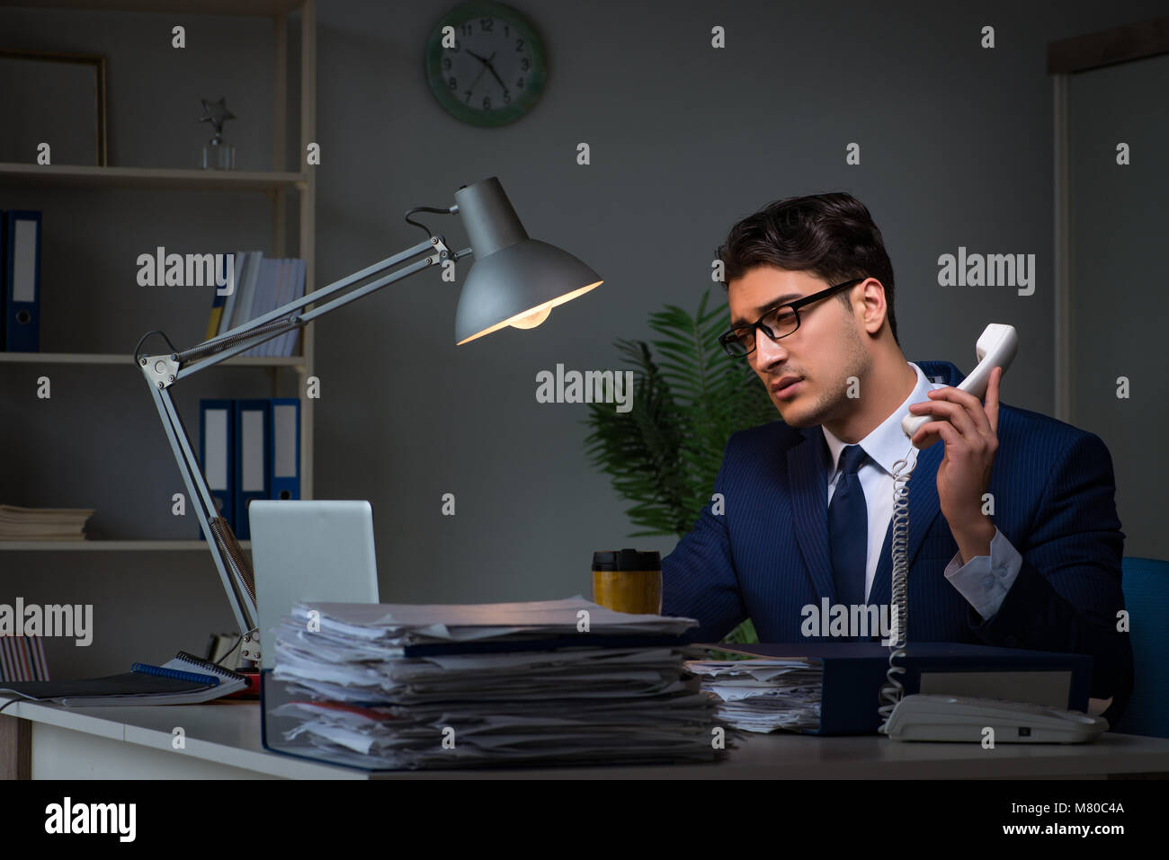 Employee working late to finish important deliverable task Stock Photo ...