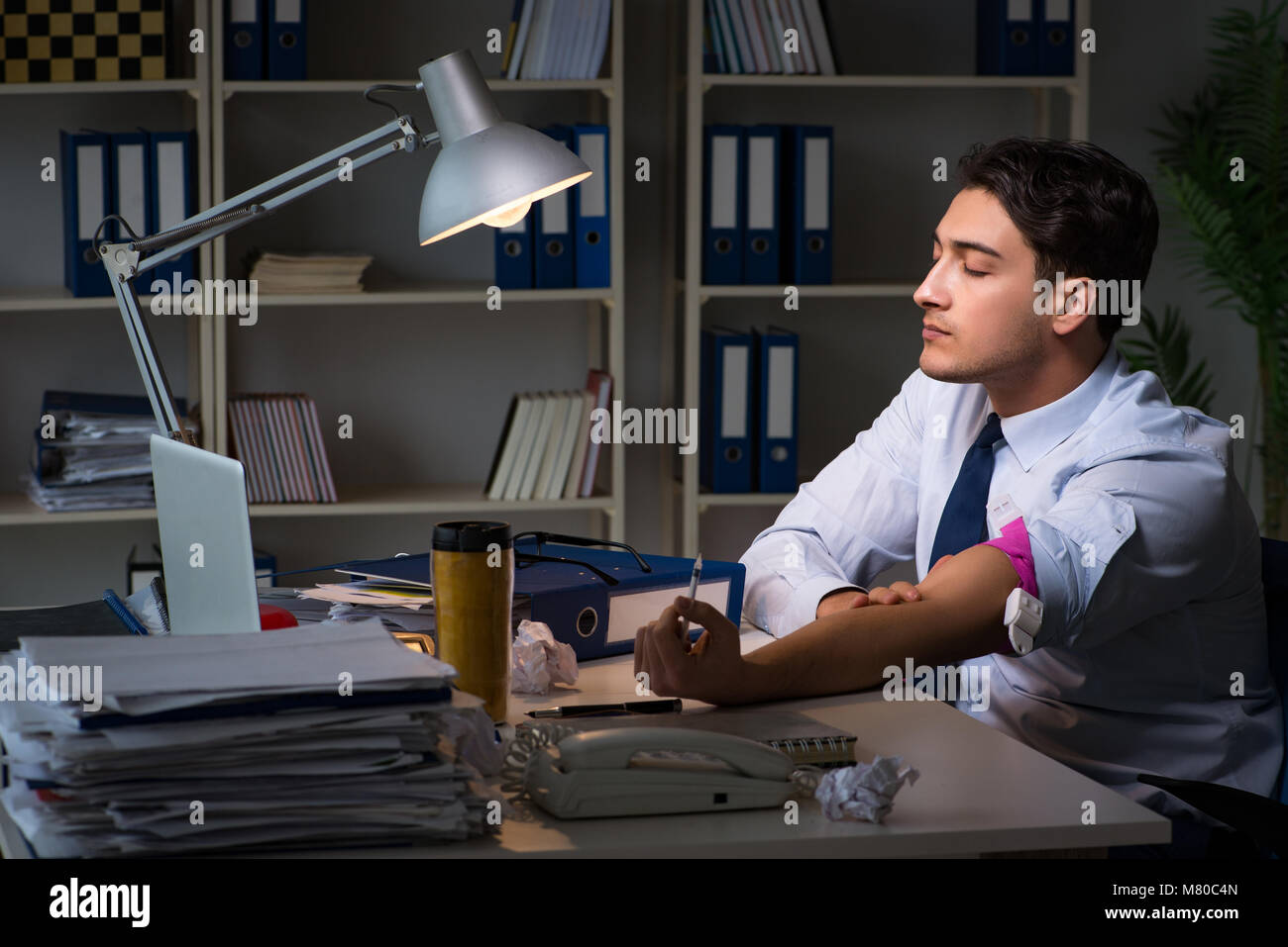 Employee relieving stress from overtime with drugs narcotics Stock ...