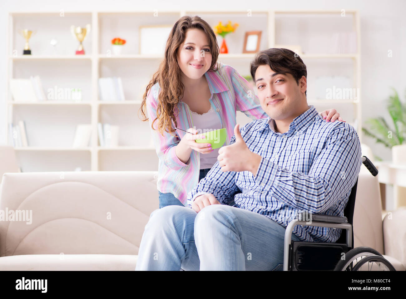 Young family taking care of each other Stock Photo - Alamy
