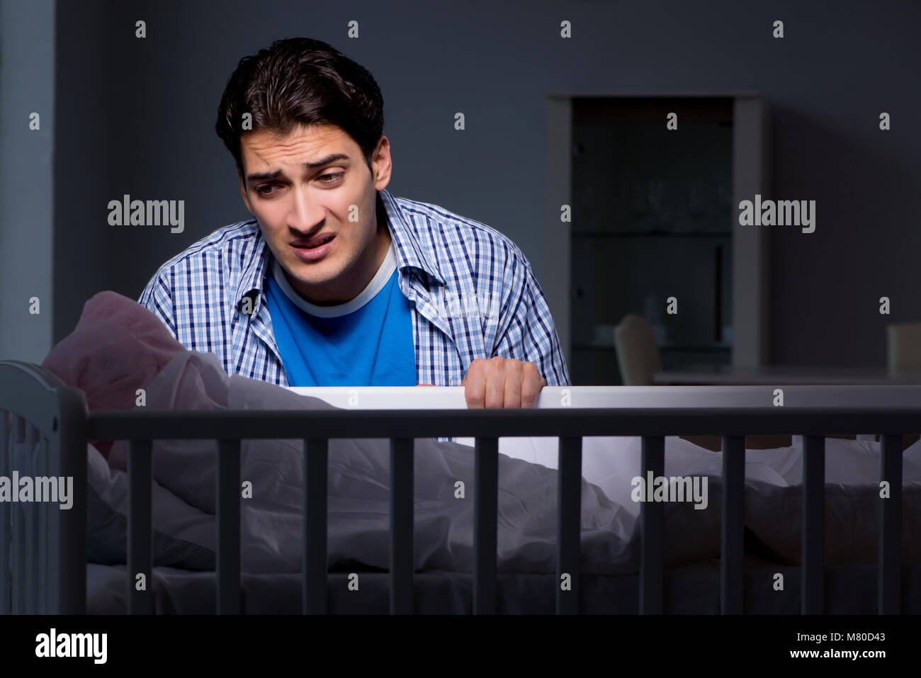Young father under stress due to baby crying at night Stock Photo - Alamy