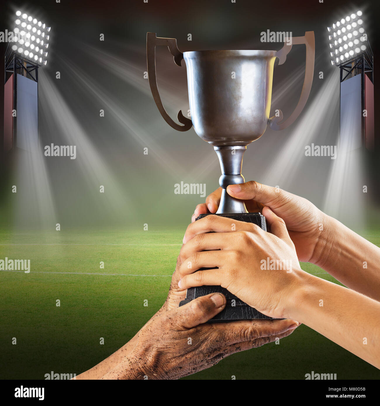 Man holding up a trophy cup is winner Stock Photo - Alamy