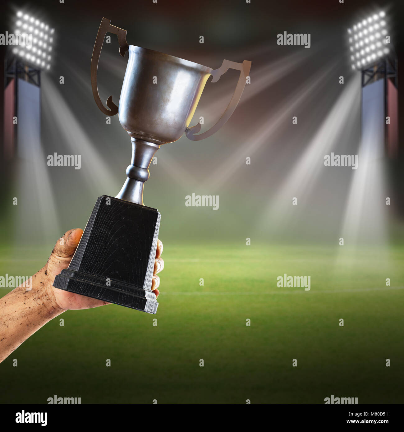 Man holding up a trophy cup is winner Stock Photo - Alamy