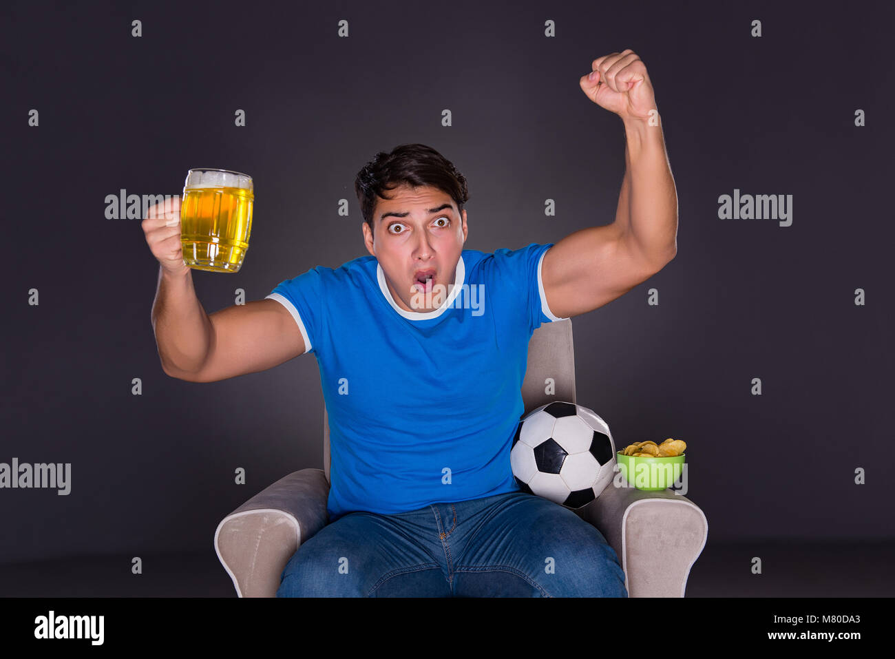 Man watching sports on gray background Stock Photo - Alamy