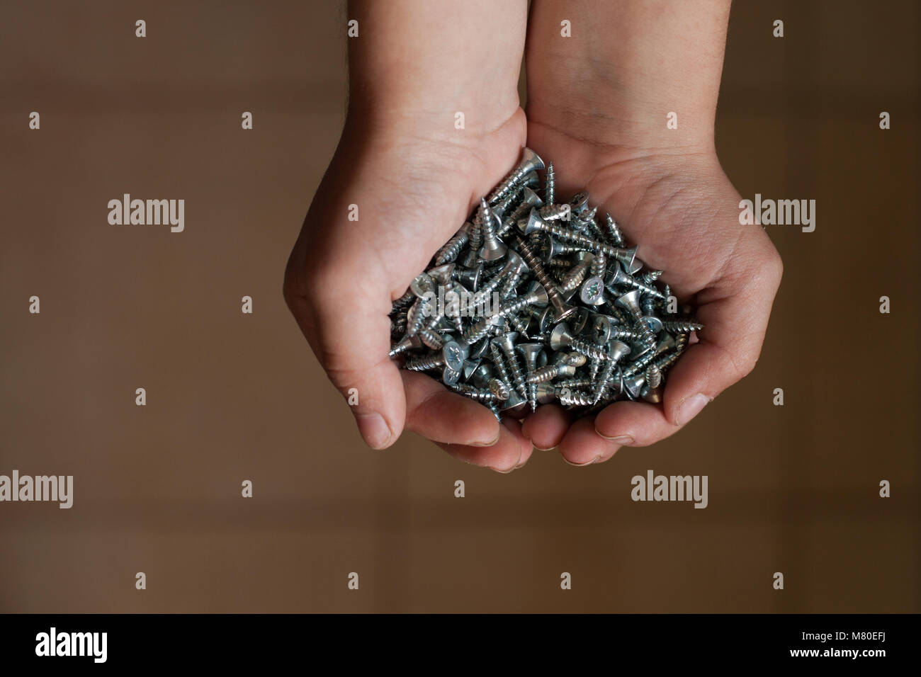 Hand holding screws hi-res stock photography and images - Alamy
