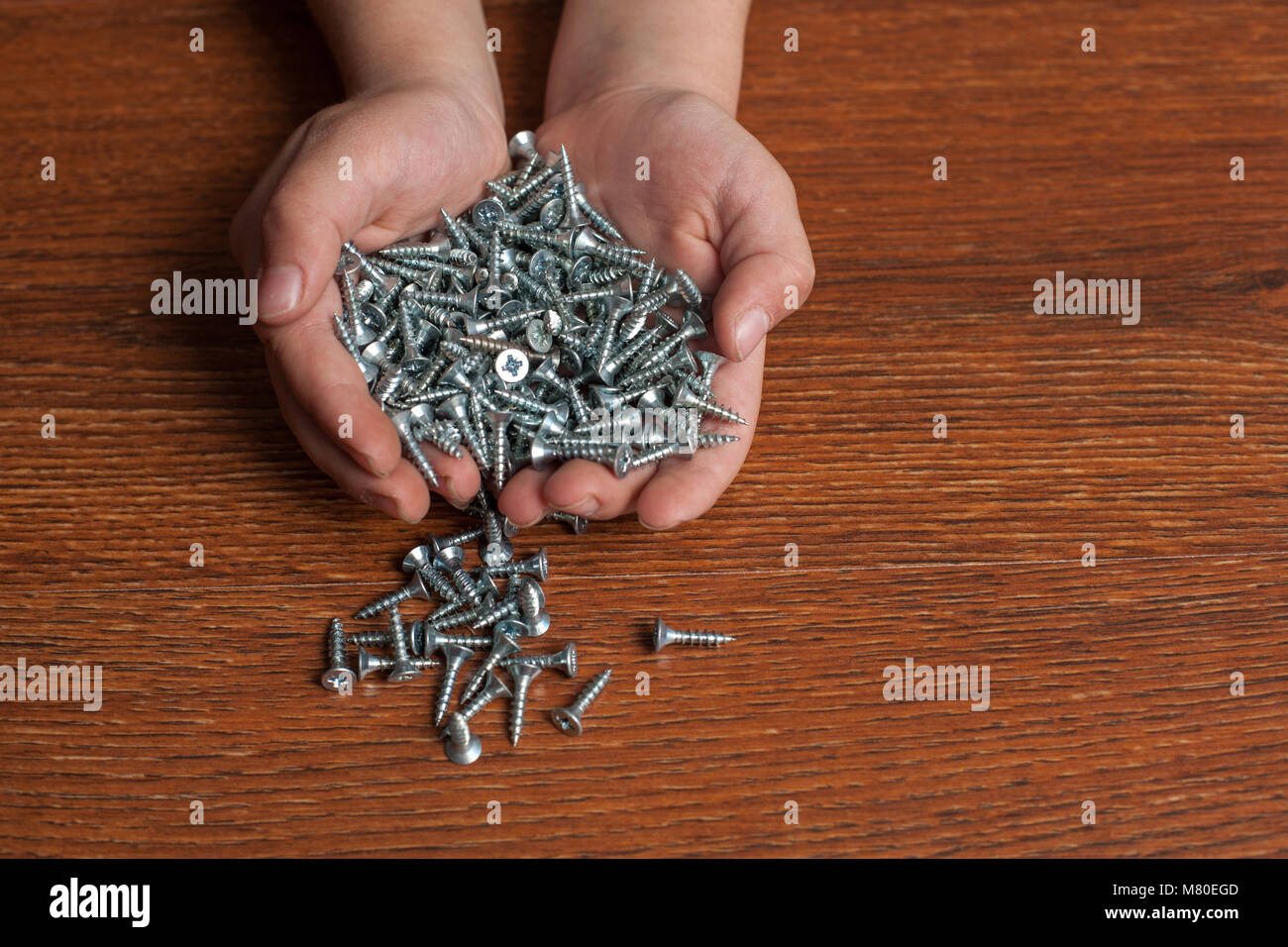 Hand holding metal screws construction hi-res stock photography and ...