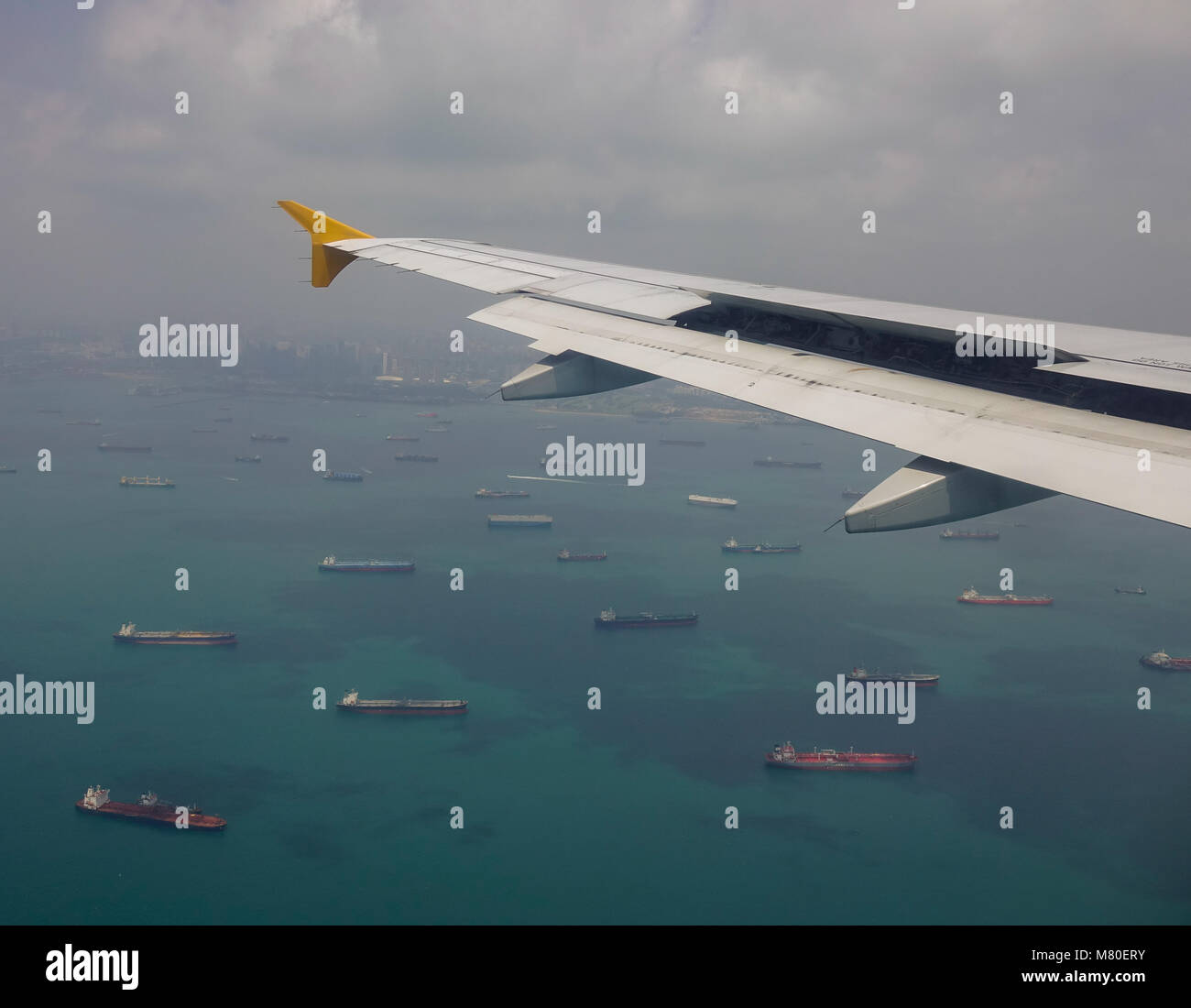 Airplane flying over the Singapore sea, view from airplane window Stock ...
