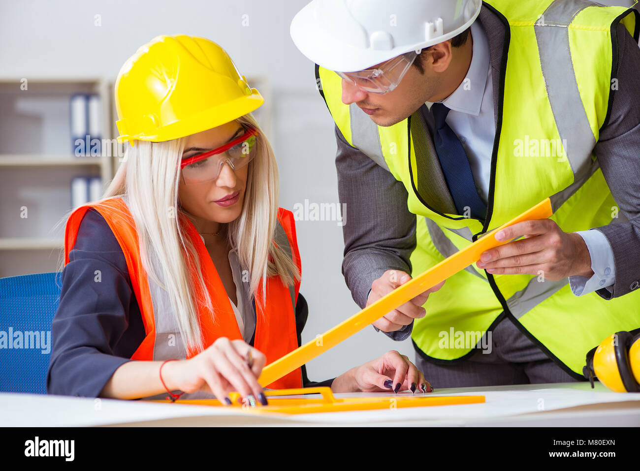 Construction workers having discussion in office before starting ...
