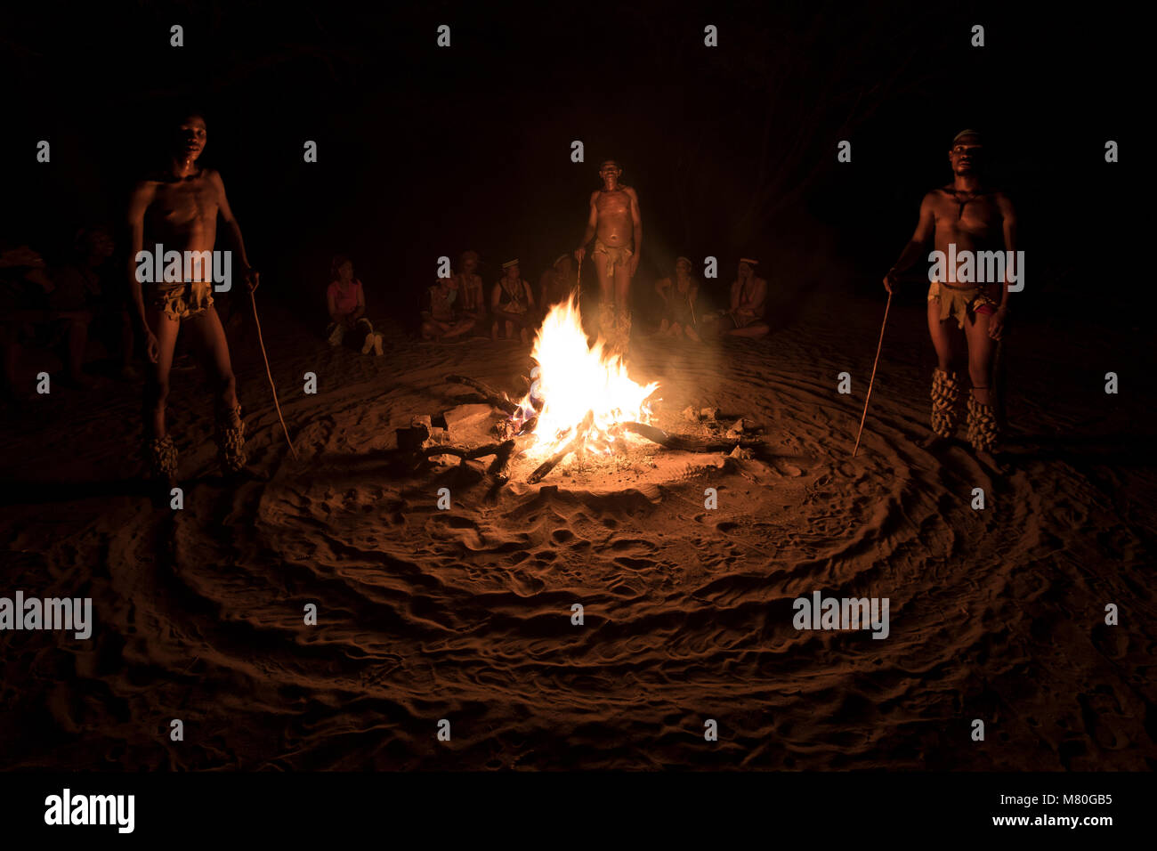 San Bushmen dance around a fire in Ghanzi, Botswana Stock Photo - Alamy