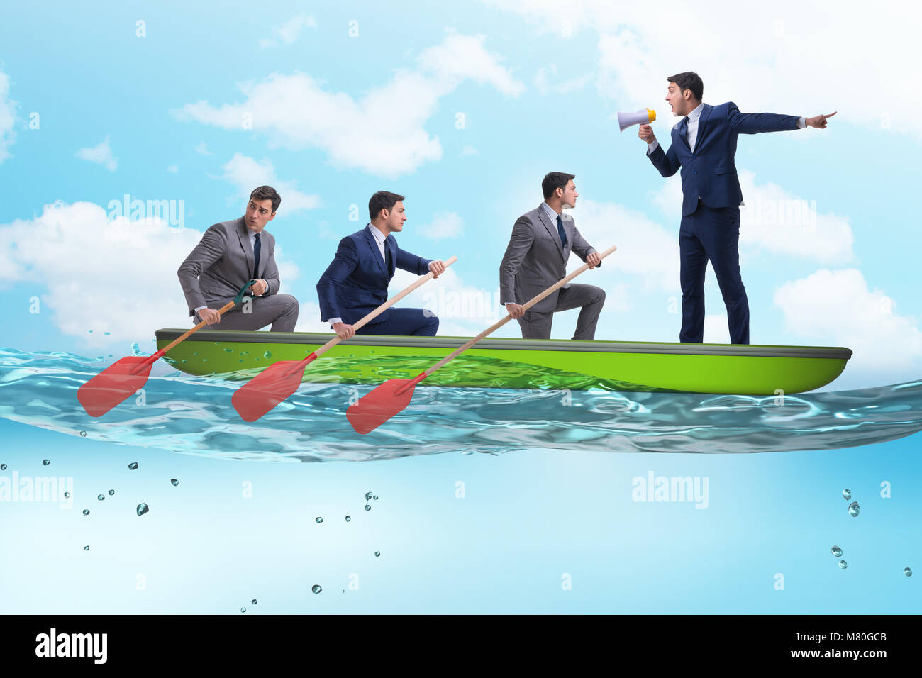 Team of businessmen in teamwork concept with boat Stock Photo - Alamy
