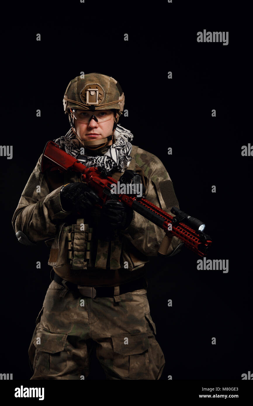 Portrait of soldier with arms on empty black background Stock Photo - Alamy