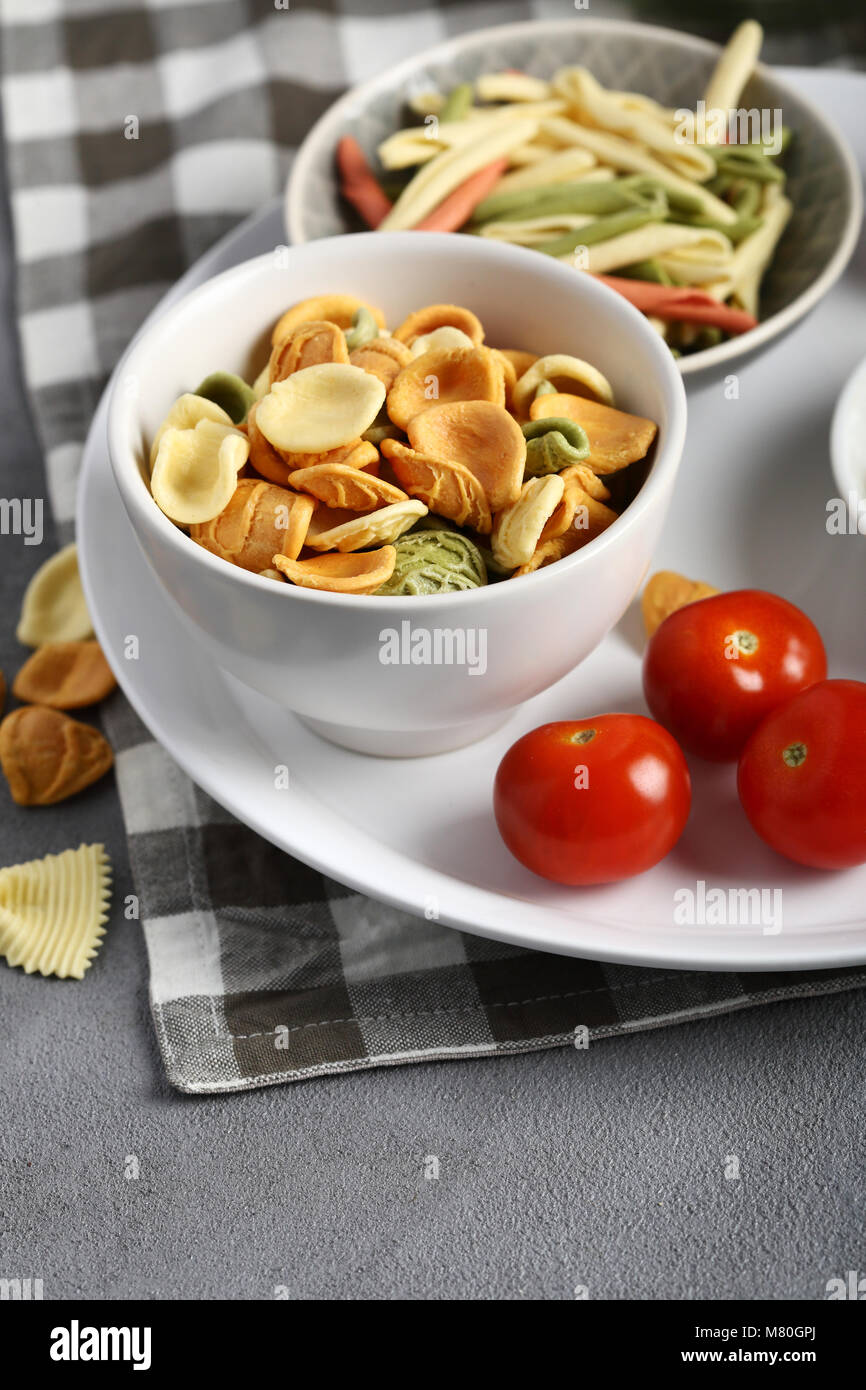 Two types Raw pasta in small bowl, food closeup Stock Photo - Alamy