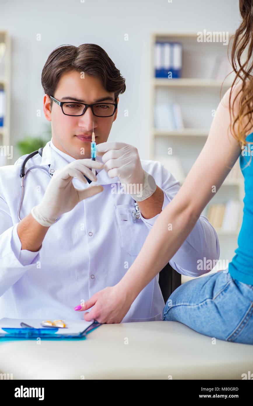 Patient visitng doctor for annual flu shot inoculation for prevention ...