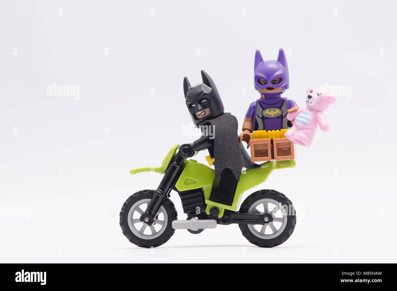 lego batman riding dirt bike with batgirl sitting on the back.isolated ...