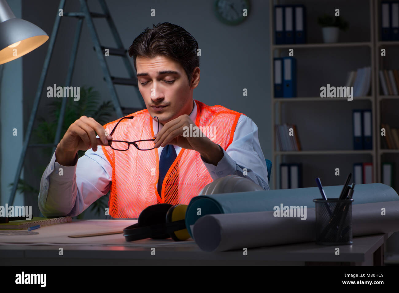 Construction architect working on drawings late at night Stock Photo ...