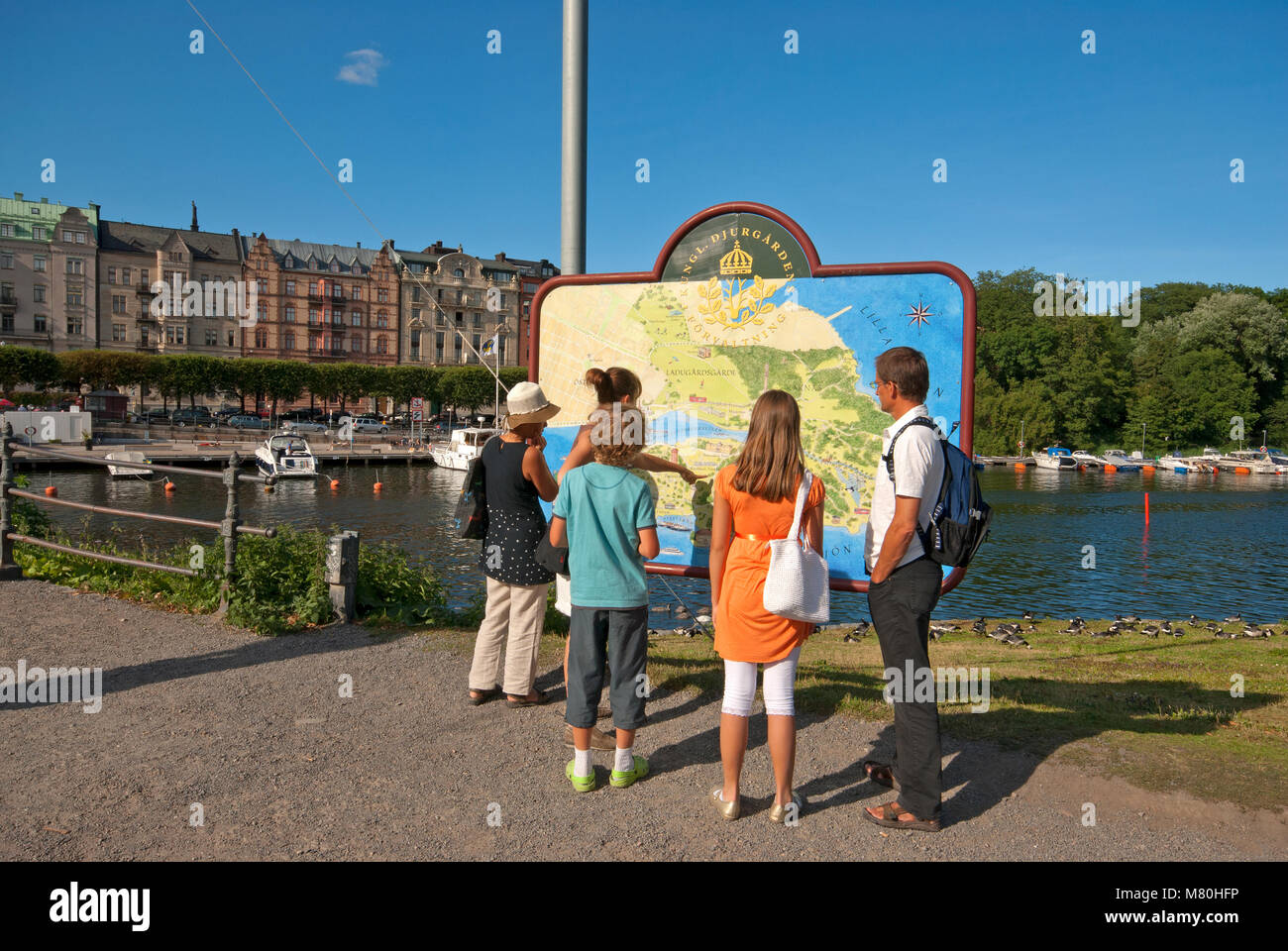 Tourists checking a map sign in Djurgården Island, Stockholm, Sweden ...