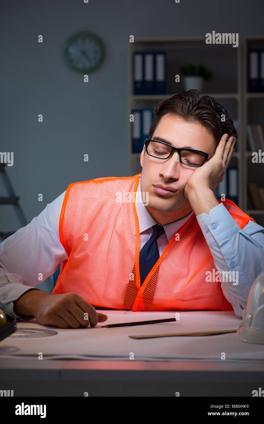 Construction architect working on drawings late at night Stock Photo ...