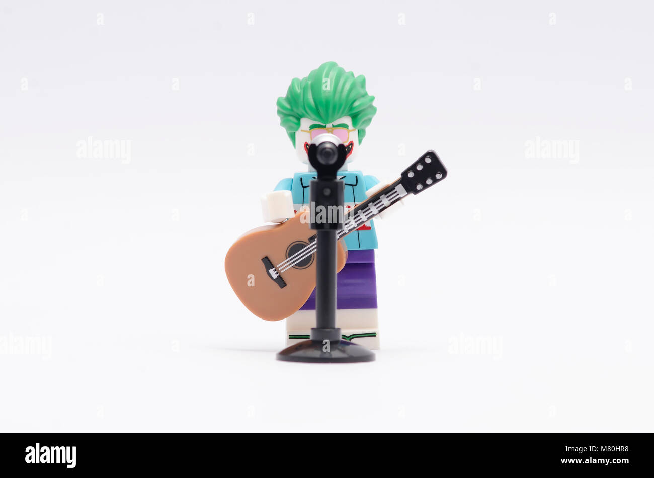 lego joker mini figure holding a guitar with microphone isolated on ...