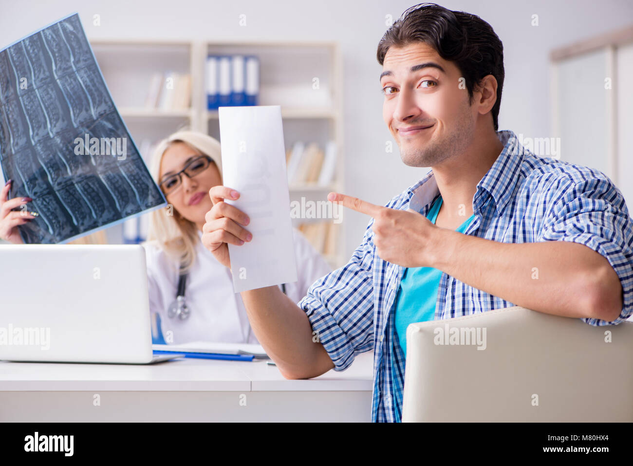 Male patient angry at expensive healthcare bill Stock Photo - Alamy