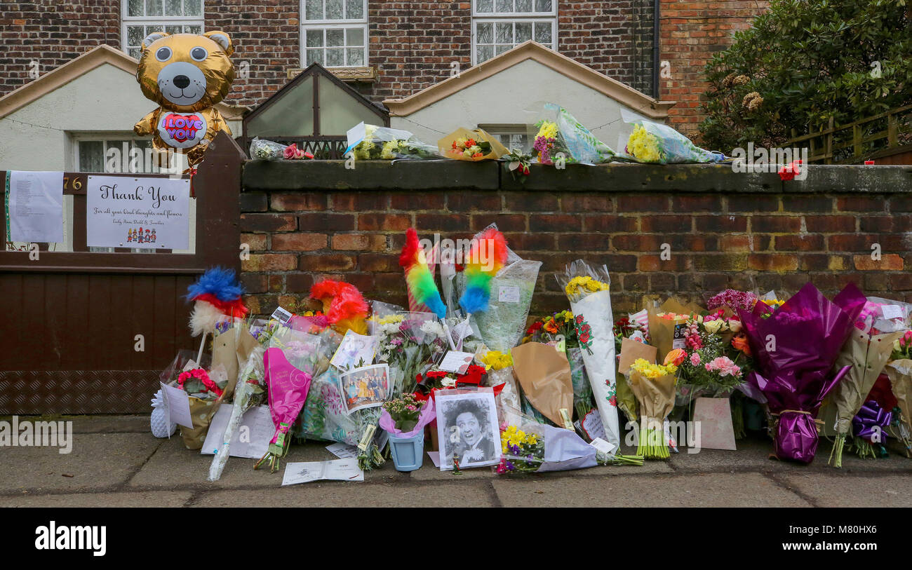 Floral tributes grow outside the home of Liverpool comedian Sir Ken ...
