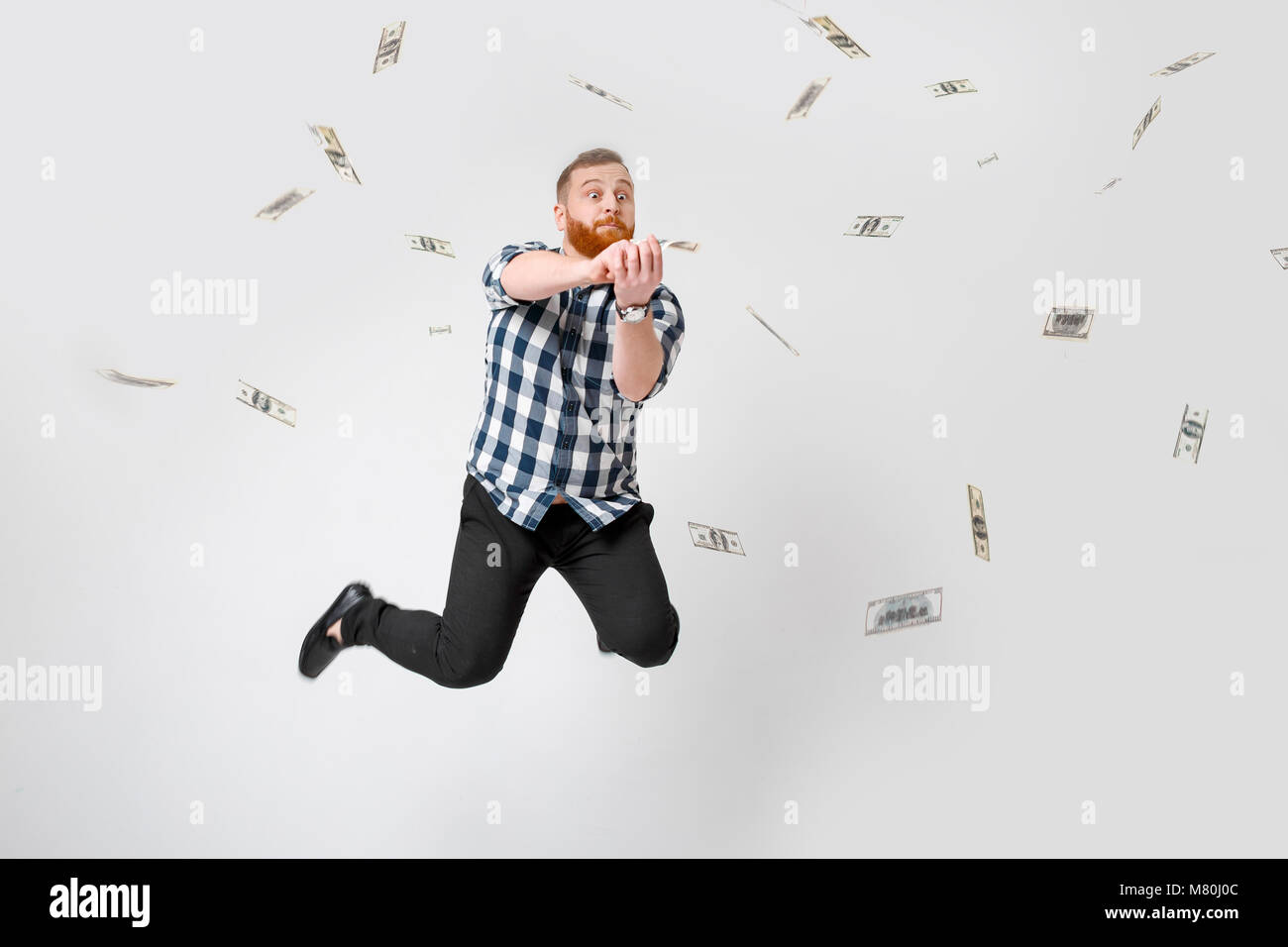 man standing under money rain Stock Photo - Alamy
