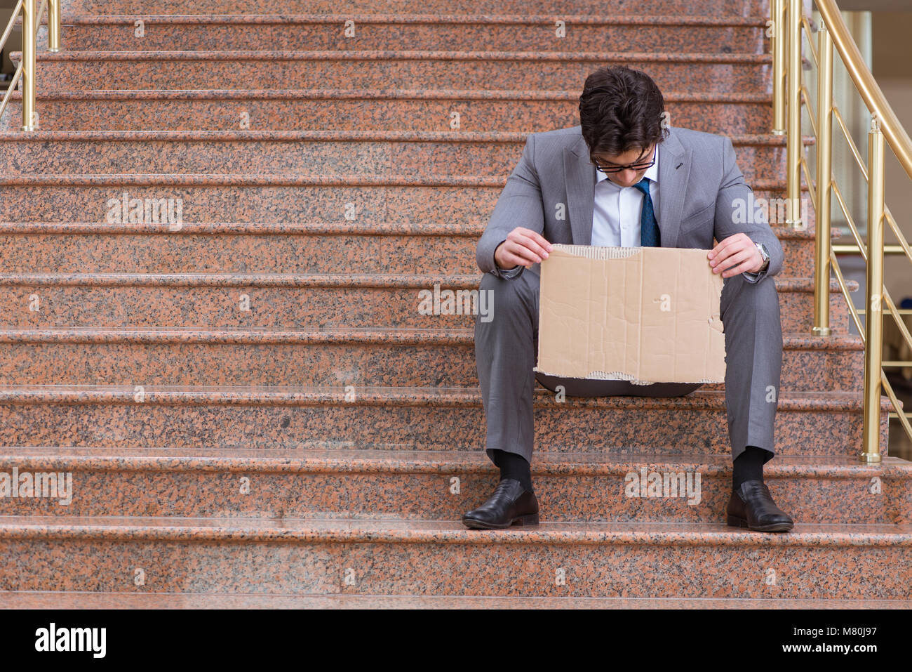 Desperate businessman begging on the street Stock Photo - Alamy